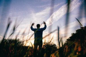 Man Raising Hands In Forest (2)