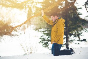 Man Praying in the Snow