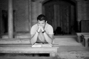 Man Praying in Old Church