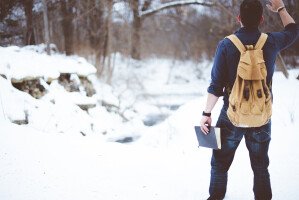 Man, Praying With Bible in Snow