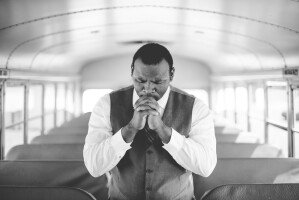 Man Praying on Bus